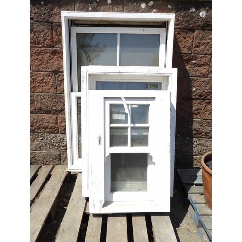 Three wooden casement windows together with one other