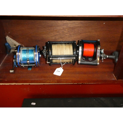 Two multiplier fishing reels by Penn together with another by Mitchell