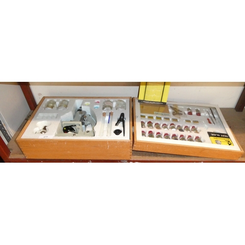 A mid century microscope and laboratory set contained within a fitted box