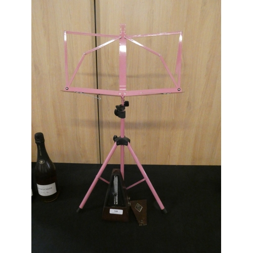 A folding music stand together with a metronome