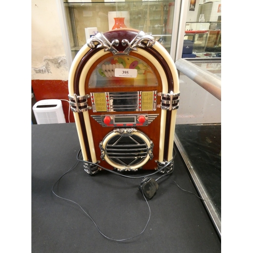 A compact disc music system modelled in the form of an American Jukebox