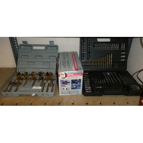 A drill and bit set, a router set and a 12 volt air compressor and lamp