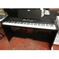 A Korg XE20 digital ensemble piano