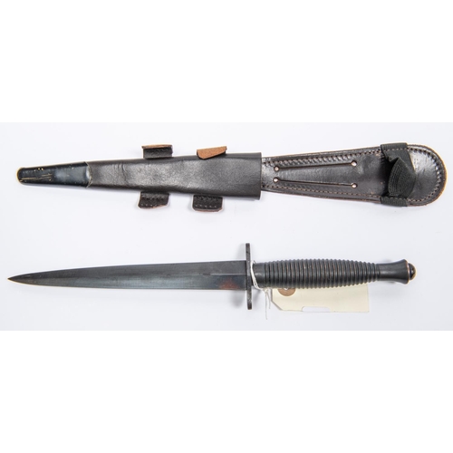 A Third pattern FS fighting knife, blued blade 6¾", ribbed blackened ...