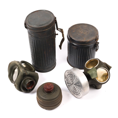 WWII German army gas mask in original tin, a civilian similar. (2) £50-70