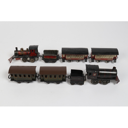 Two early clockwork and electric tinplate train sets. A clockwork 24mm ...