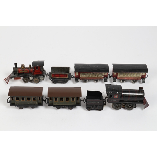 Two early clockwork and electric tinplate train sets. A clockwork 24mm ...