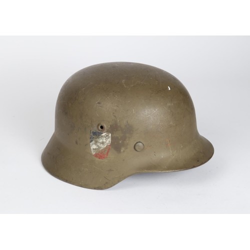 A Third Reich M40 steel helmet, painted field grey with crudely painted ...