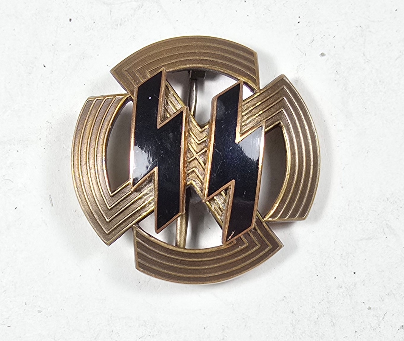 A Third Reich Germanic Proficiency Runes badge in bronze, the back ...