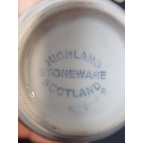 A HIGHLAND STONEWARE, SCOTLAND LAMP decorated all round with a Highland ...