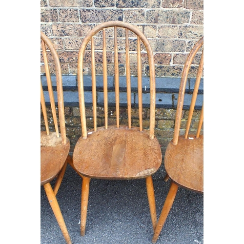 A SET OF FOUR ERCOL STYLE STICK-BACK CHAIRS the hoop backs 97cm high ...