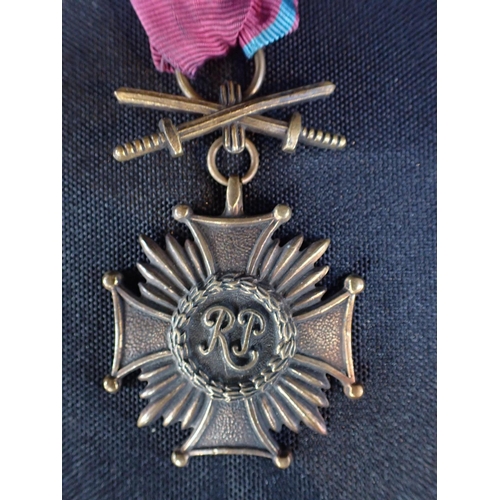 A POLISH CROSS OF MERIT in bronze with swords, with a Polish breast ...