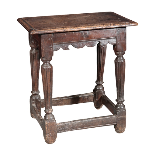 AN ELM JOINT STOOL 17th century, the stepped rectangular seat with wide ...