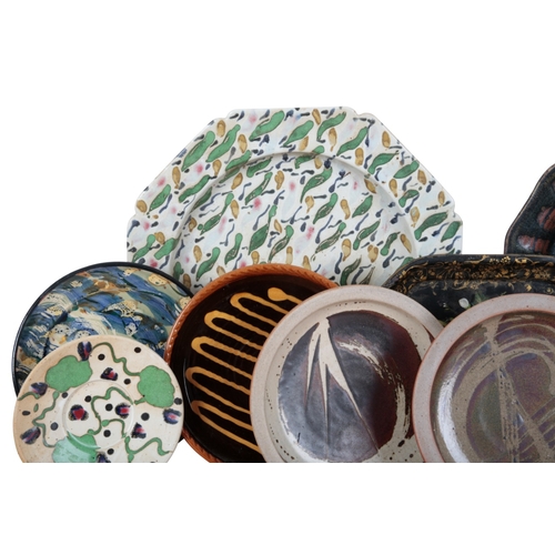 A LARGE COLLECTION OF STUDIO POTTERY PLATES comprising various examples ...