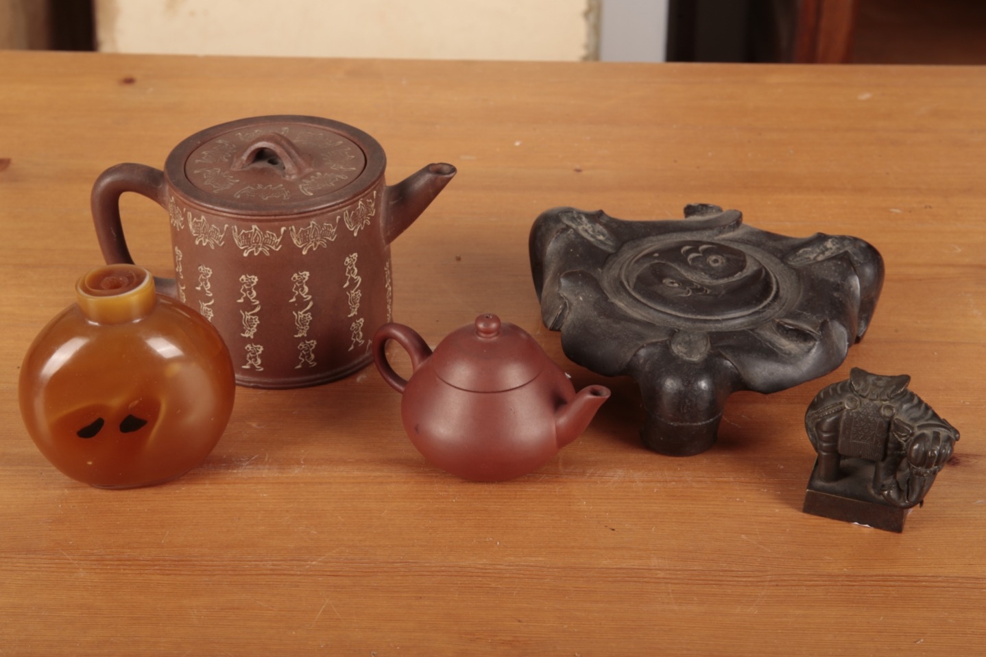 A CHINESE YXING RED WARE CYLINDRICAL TEAPOT the body impressed with figures and birds, 9cm high; to