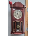 A Maxim 31 day wall hanging clock with glass front, carved detail and ...