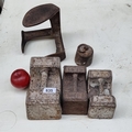 Five very heavy cast iron objects including four weights and a cobbler ...