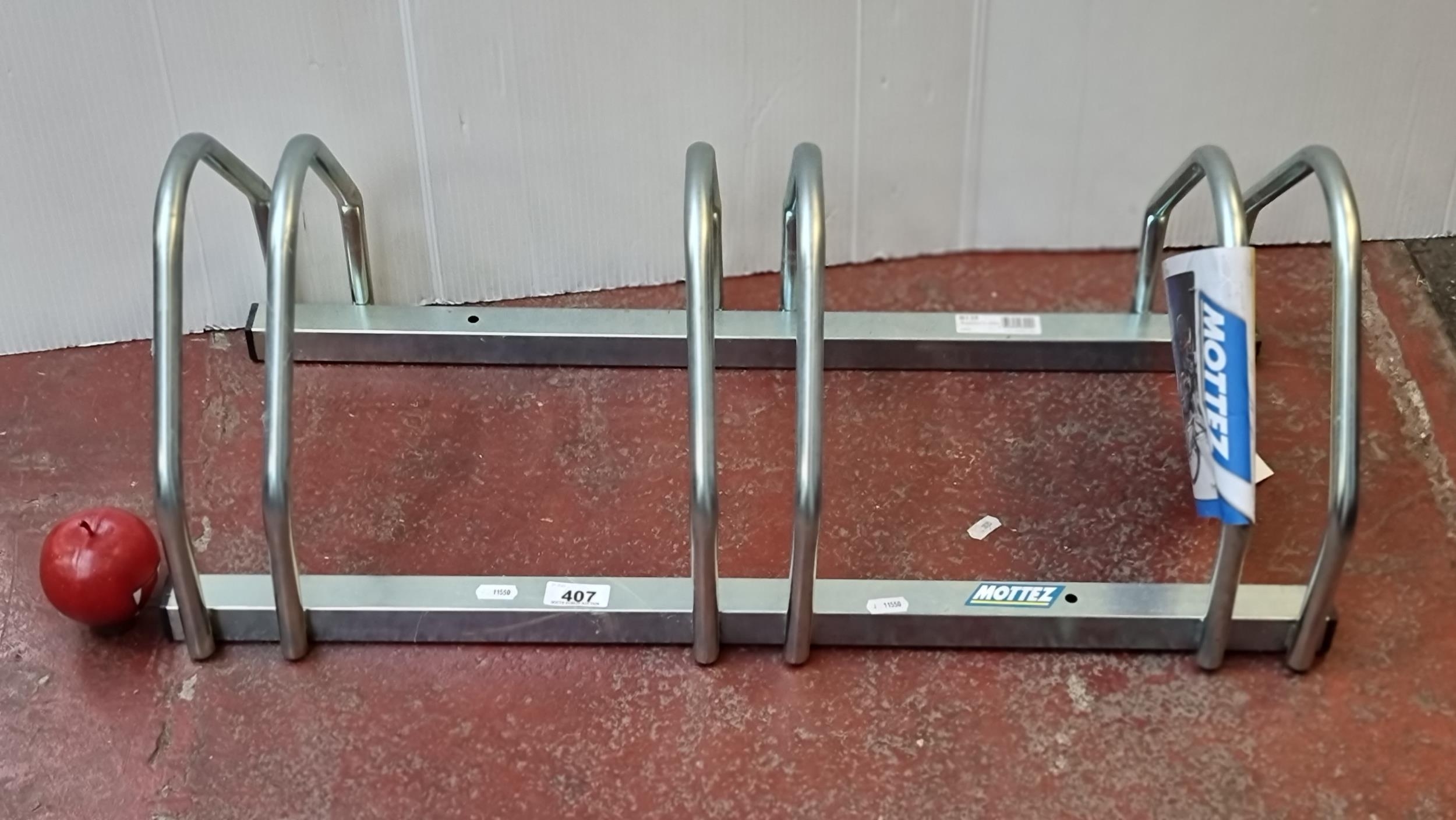A brand new Mottez floor bike rack with spaces for three bicycles. RRP ...