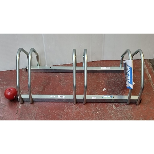 A brand new Mottez floor bike rack with spaces for three bicycles. RRP ...
