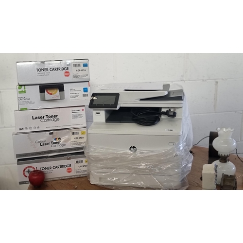 A HP Colour Laser Jet MFP M477fnw printer, scanner copier, with five ...
