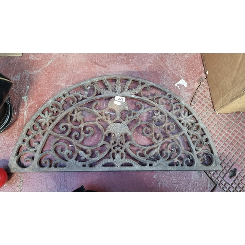A heavy Victorian cast iron door mat with curvilinear and floral design ...