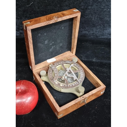 A handsome marine sundial compass with brass hardware, incised roman ...