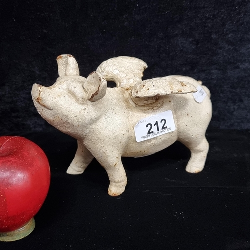 A very charming heavy cast metal piggy bank in the form of a winged pig