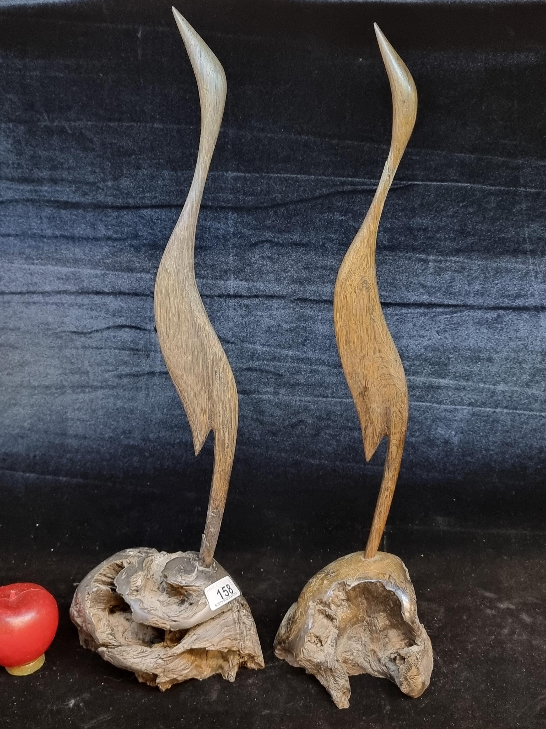 A pair of Irish bog oak sculptures depicting a pair of herons perched ...