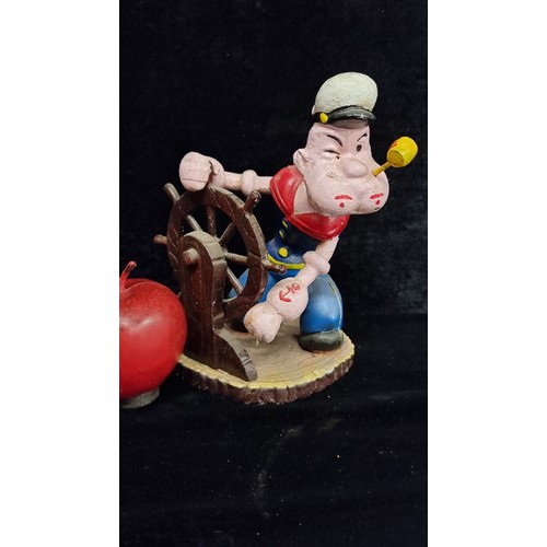 A heavy cast metal figure of the iconic character Popeye. This example ...