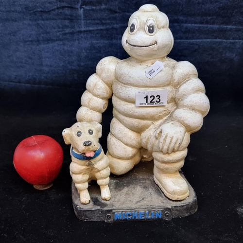 A very heavy cast metal figure of the iconic Michelin man and his dog ...