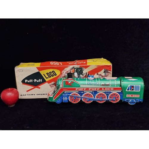 A super vintage "Puff-Puff Loco" battery operated tin model train. A ...