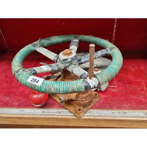 A great example of an antique ship's steering wheel attached to a gear ...