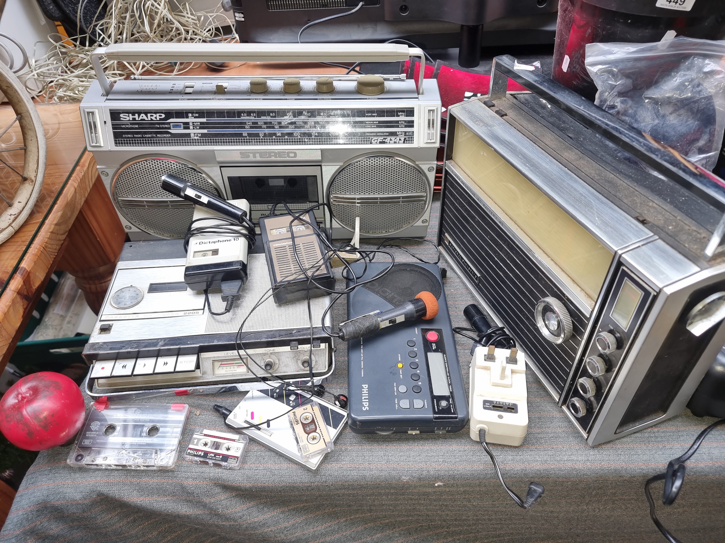 A collection of four retro radio / stereos and a cassette tape player.