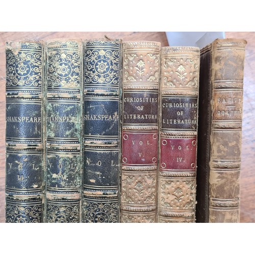 Six antique bound books, featuring intricate gold embossing on the ...