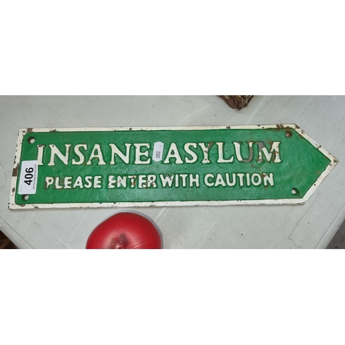 A cast metal wall plaque pointing in a direction for an insane asylum ...