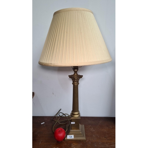 A traditional style heavy weight bras lamp with pleated cream fabric shade