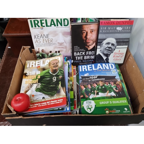 A large selection of Irish football programmes, along with two hardback ...