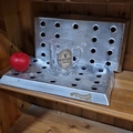 A Guinness Extra Stout glass along with two metal drip trays both ...