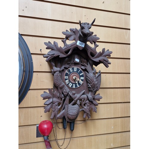A charming vintage wooden cuckoo clock. Features roman numeral dial ...
