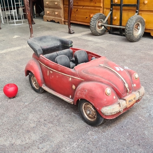 A large Mid-20th-century pressed-metal convertible toy car, red paint ...