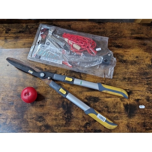 Two garden tools: aluminium-handled hedge shears with yellow grips, and ...