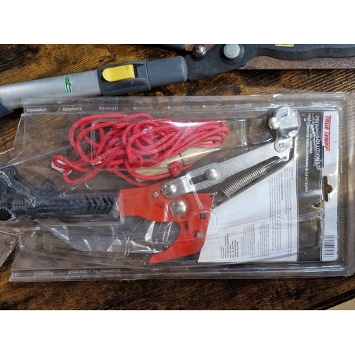 Two garden tools: aluminium-handled hedge shears with yellow grips, and ...