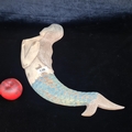 A vintage decorative hand carved wooden figure of a mermaid in a ...