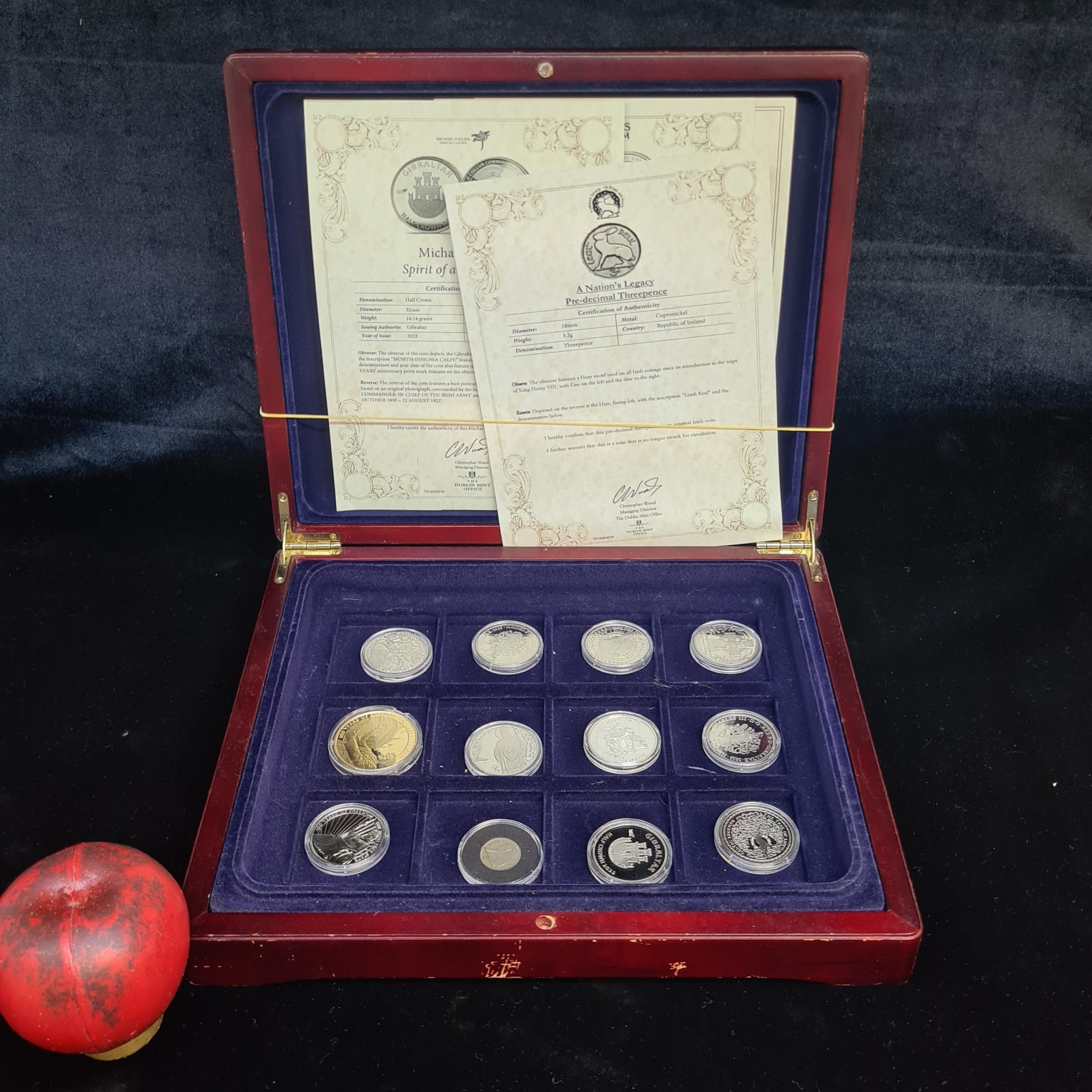 A box of 12 encapsulated uncirculated coins and medals including ...