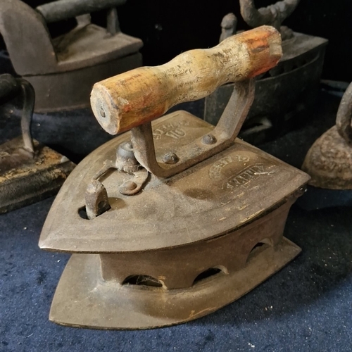 Group of six late-19th/early-20th-century cast-iron clothes irons ...