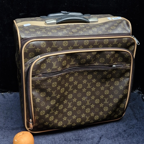 A fabulous vintage LV style rolling luggage case features three zip ...