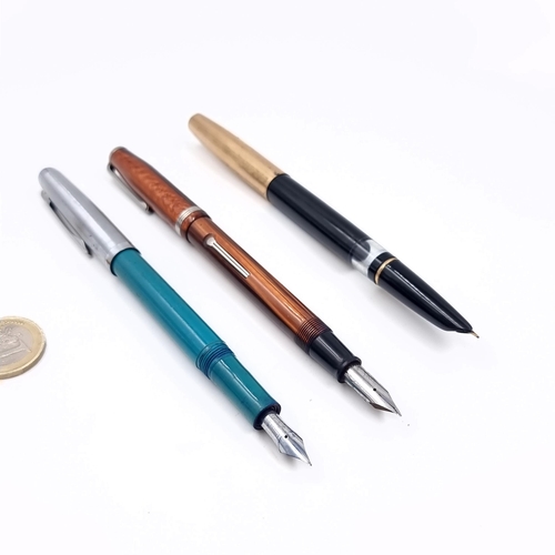 A collection of three fountain pens including an Easterbrook example.