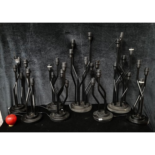 Eight black painted metal table lamp bases, each with twisted tubular ...