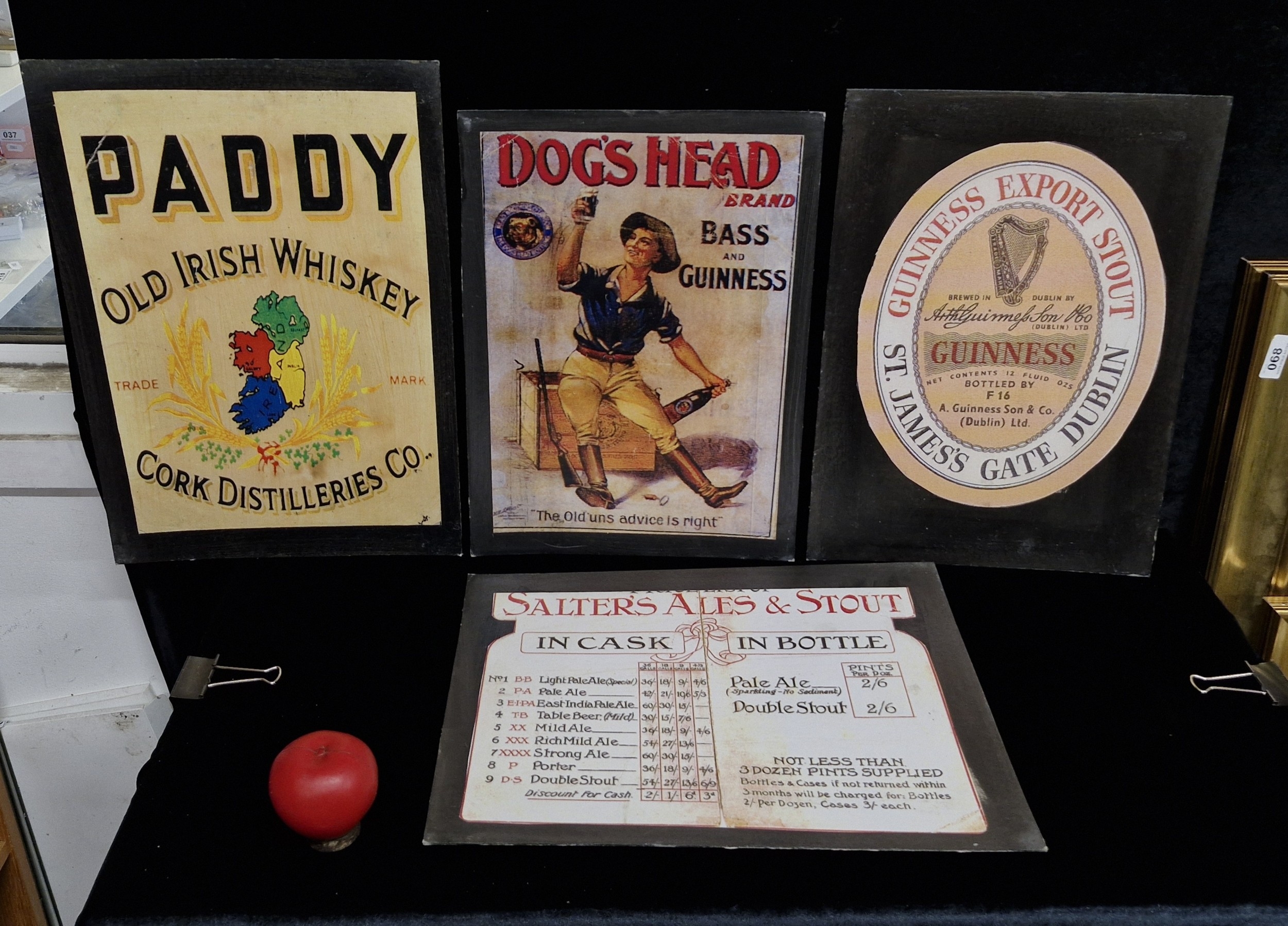 A selection of four vintage style alcohol advertisements mounted on board.
