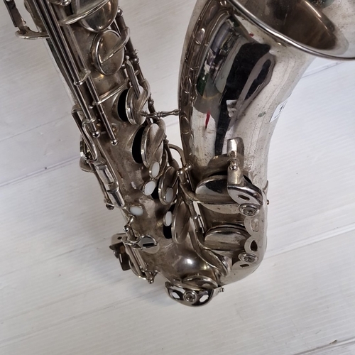 Silver-plated alto saxophone with white key touches and engraved bell ...